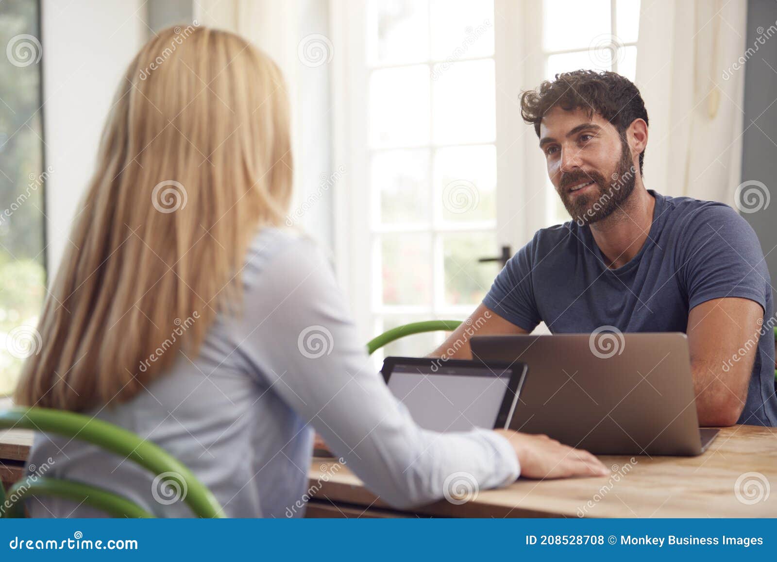 Couple with Laptop Sitting at Table Working from Home Together Stock ...
