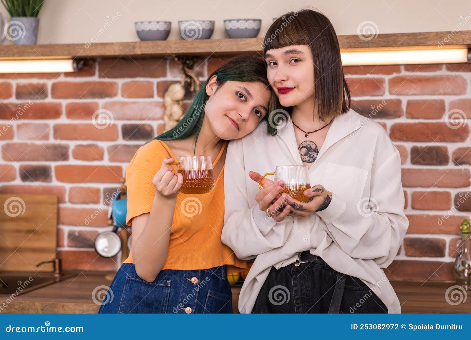 Couple Of Lesbian Girls Enjoy Coffee At Home Taking About Something