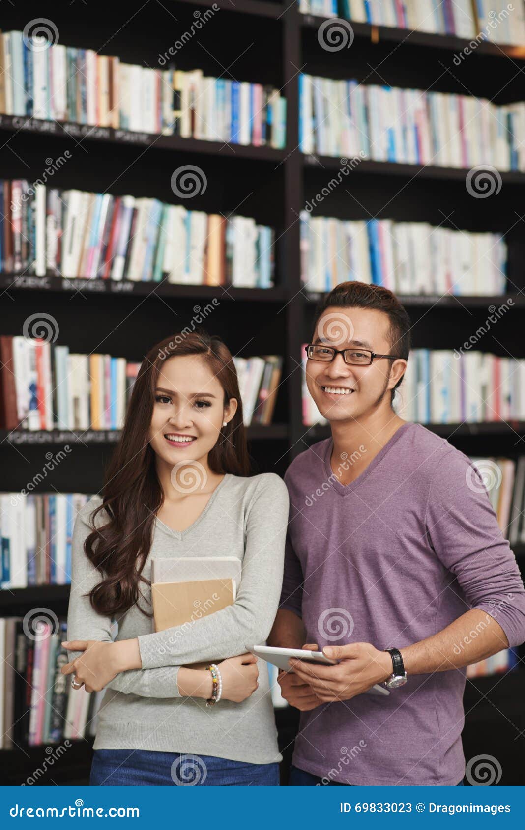 Couple in library stock image. Image of gadget, student - 69833023
