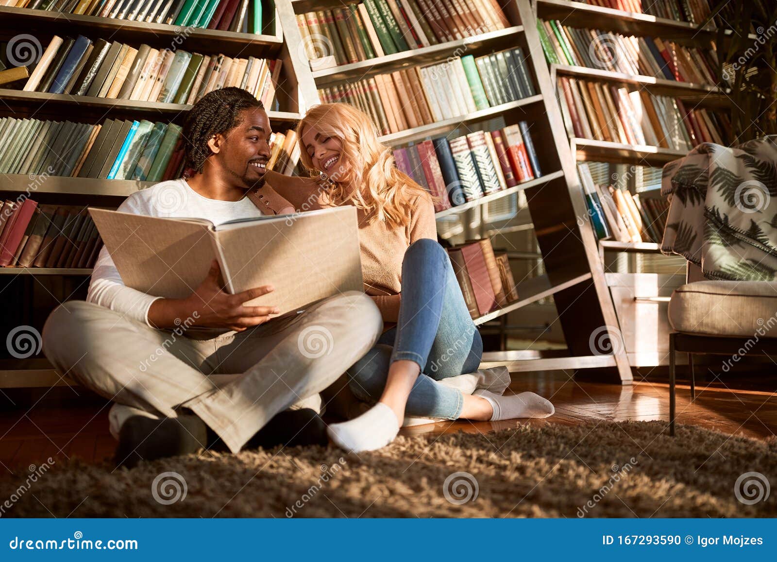 Couple in library stock photo. Image of interesting - 167293590