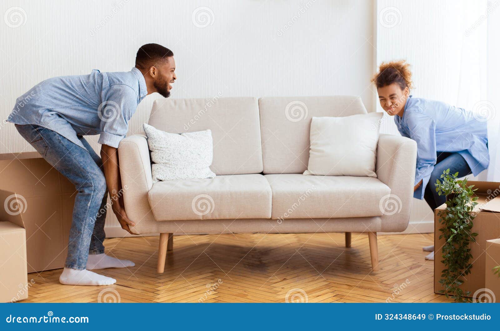Couple Lifting Sofa Standing in Empty Room after Moving House Stock ...