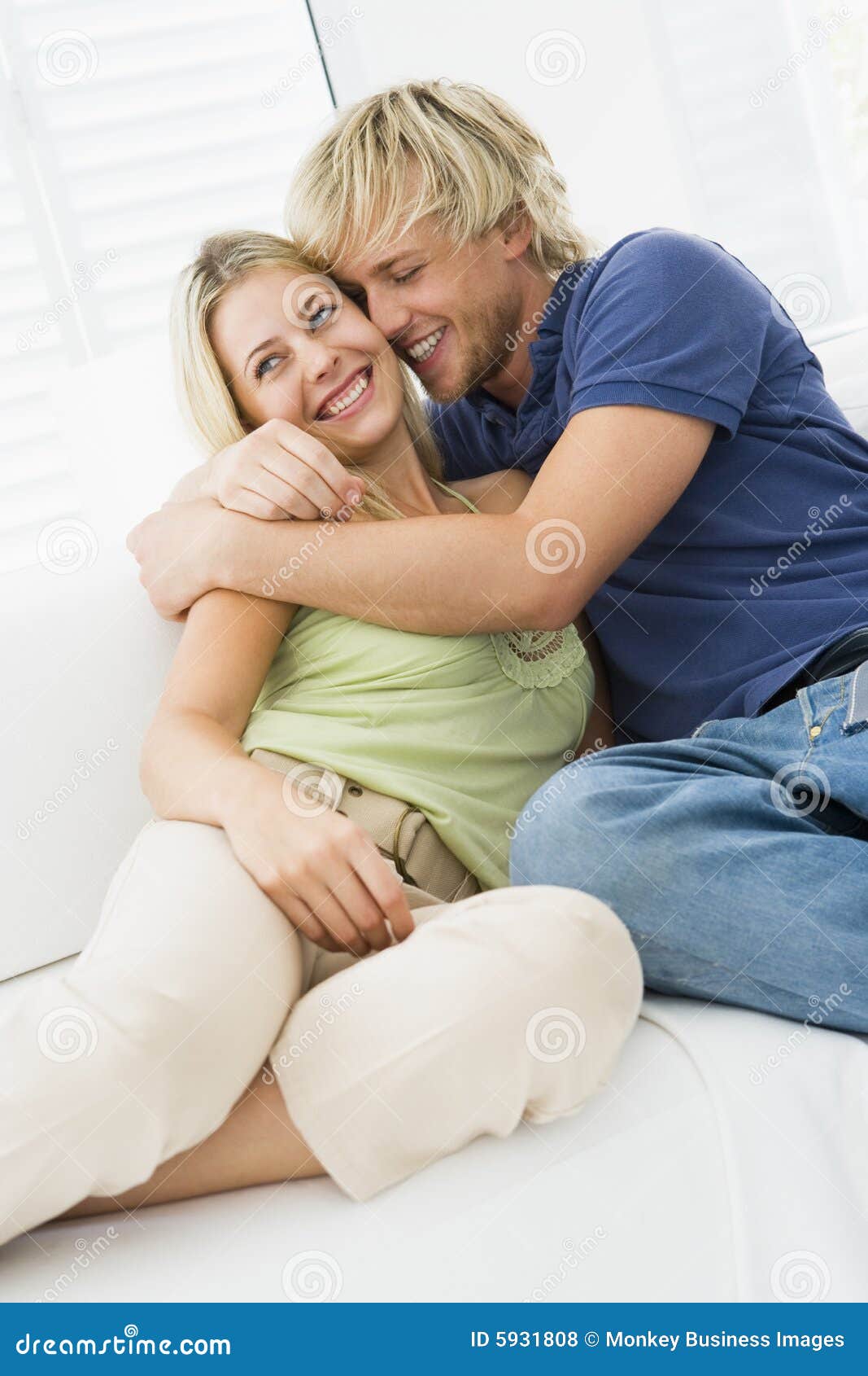 Couple in Living Room Hugging and Smiling Stock Photo - Image of ...