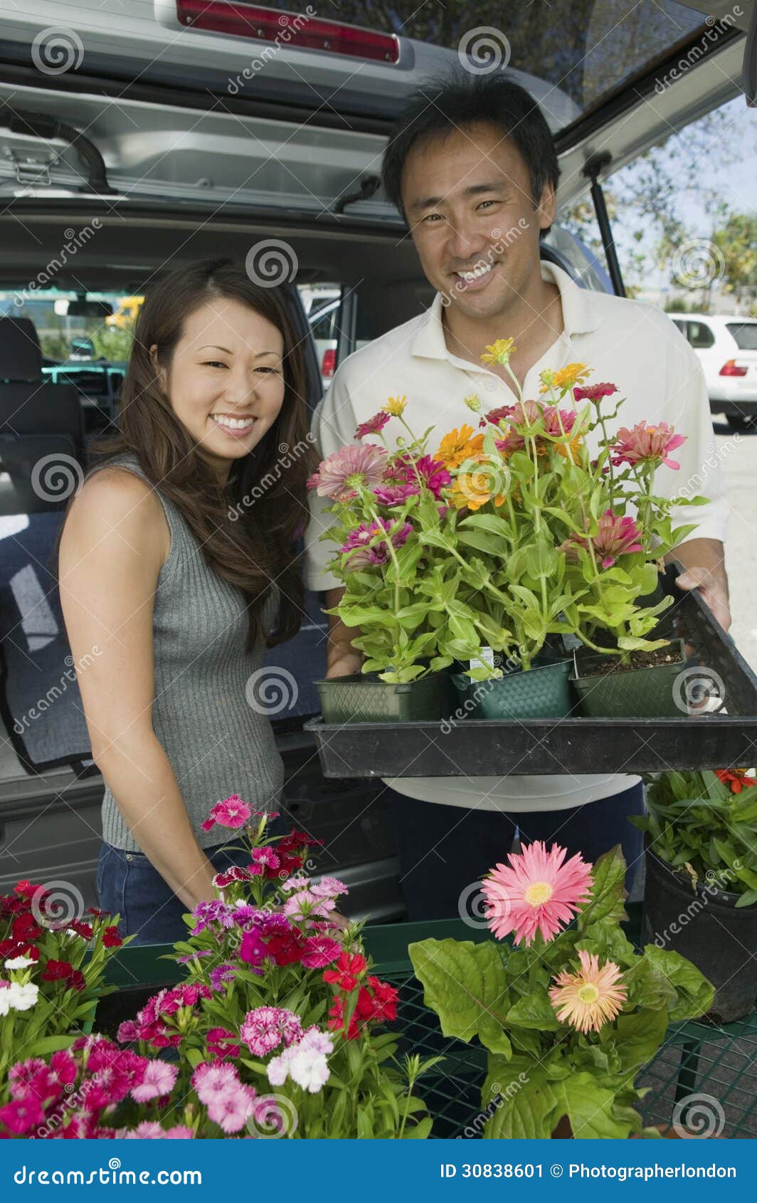 Couple Loading Flowers into Back of SUV Portrait Stock Image - Image of ...