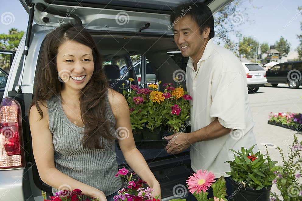 Couple Loading Flowers into Car Stock Image - Image of couple, garden ...