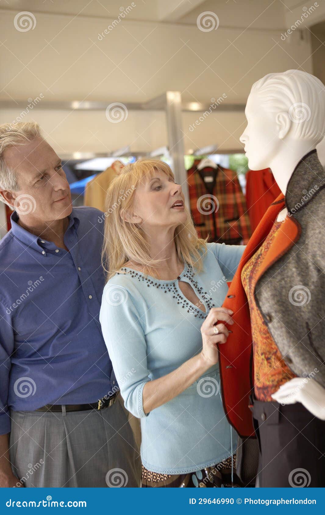 Couple Looking at Clothes in Clothing Store Stock Photo - Image of ...