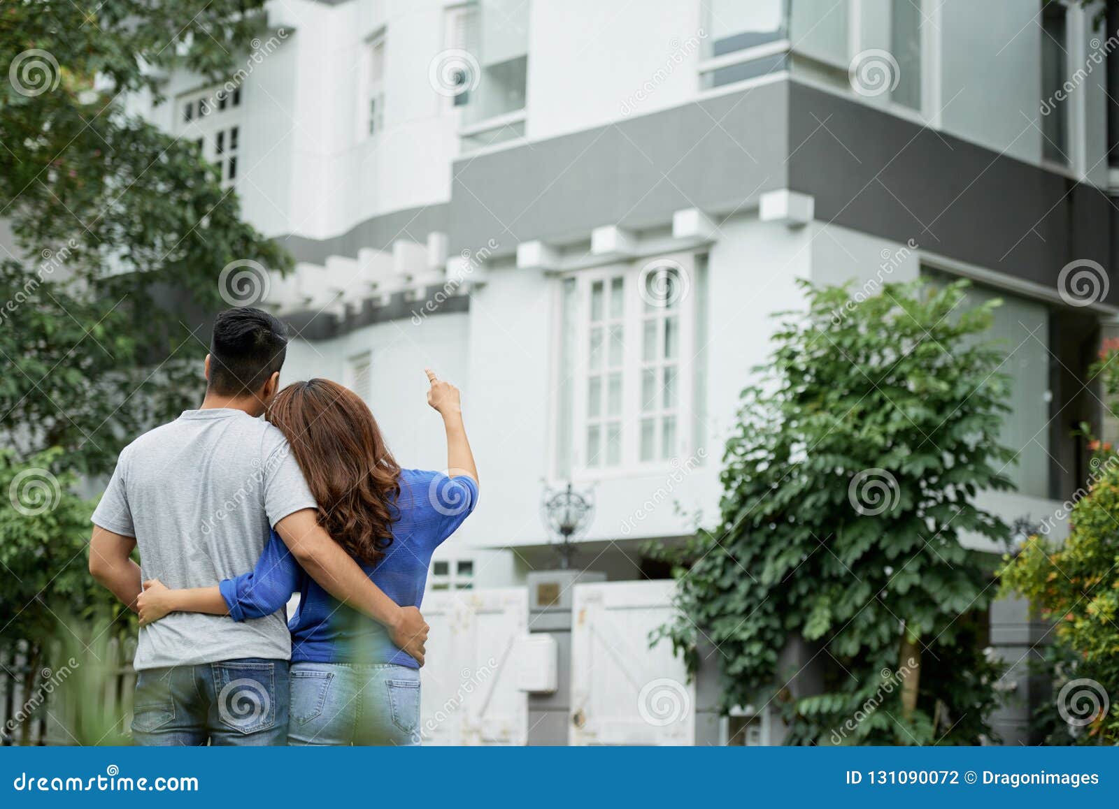 Couple looking at house stock photo. Image of building - 131090072