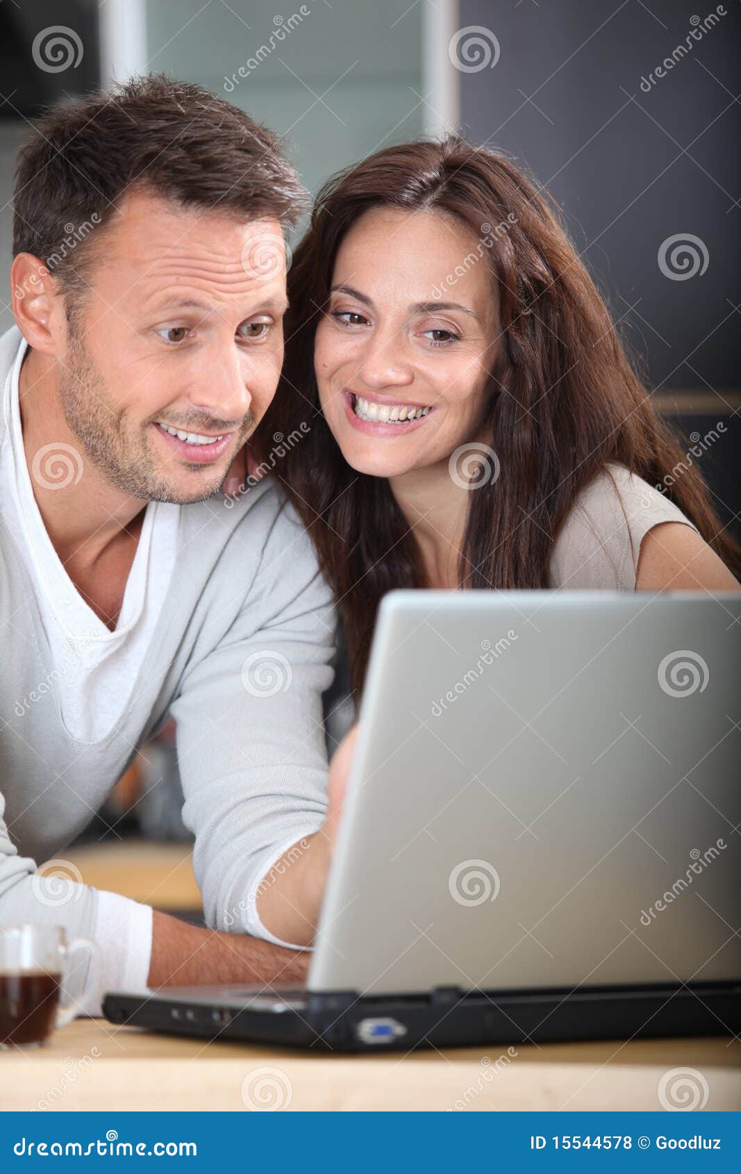Couple looking at internet stock photo. Image of smiling - 15544578