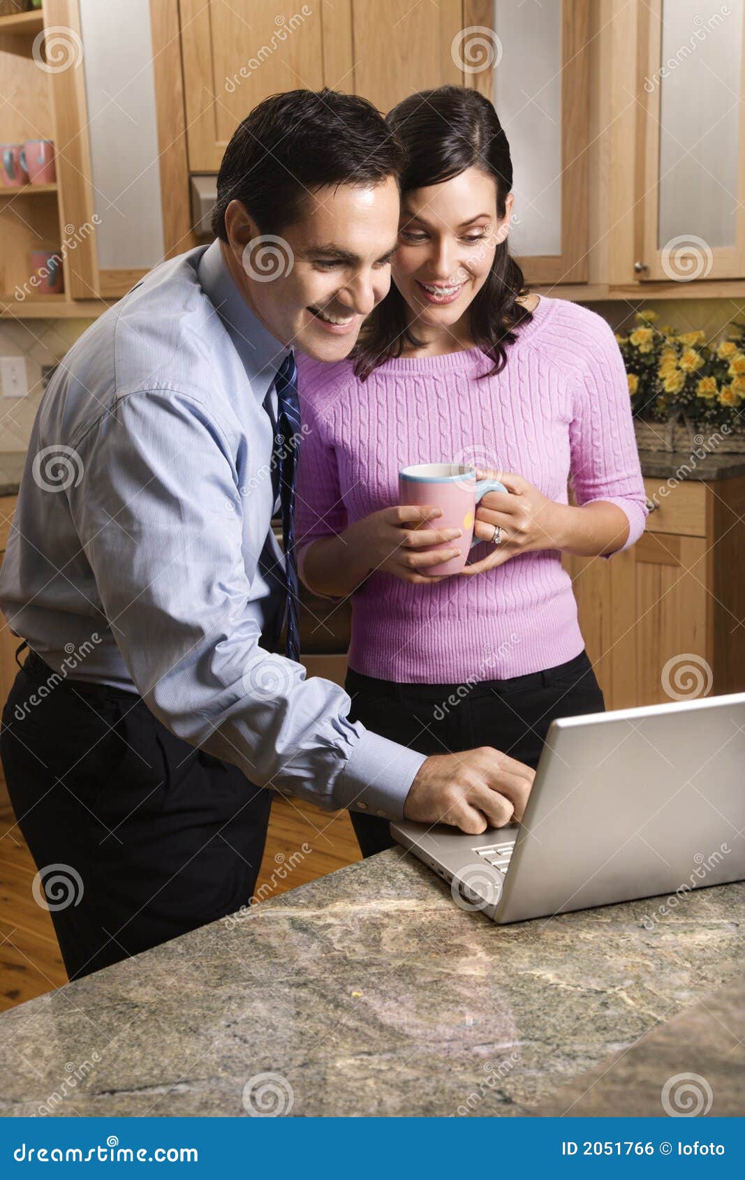 Couple looking at laptop. stock photo. Image of color - 2051766