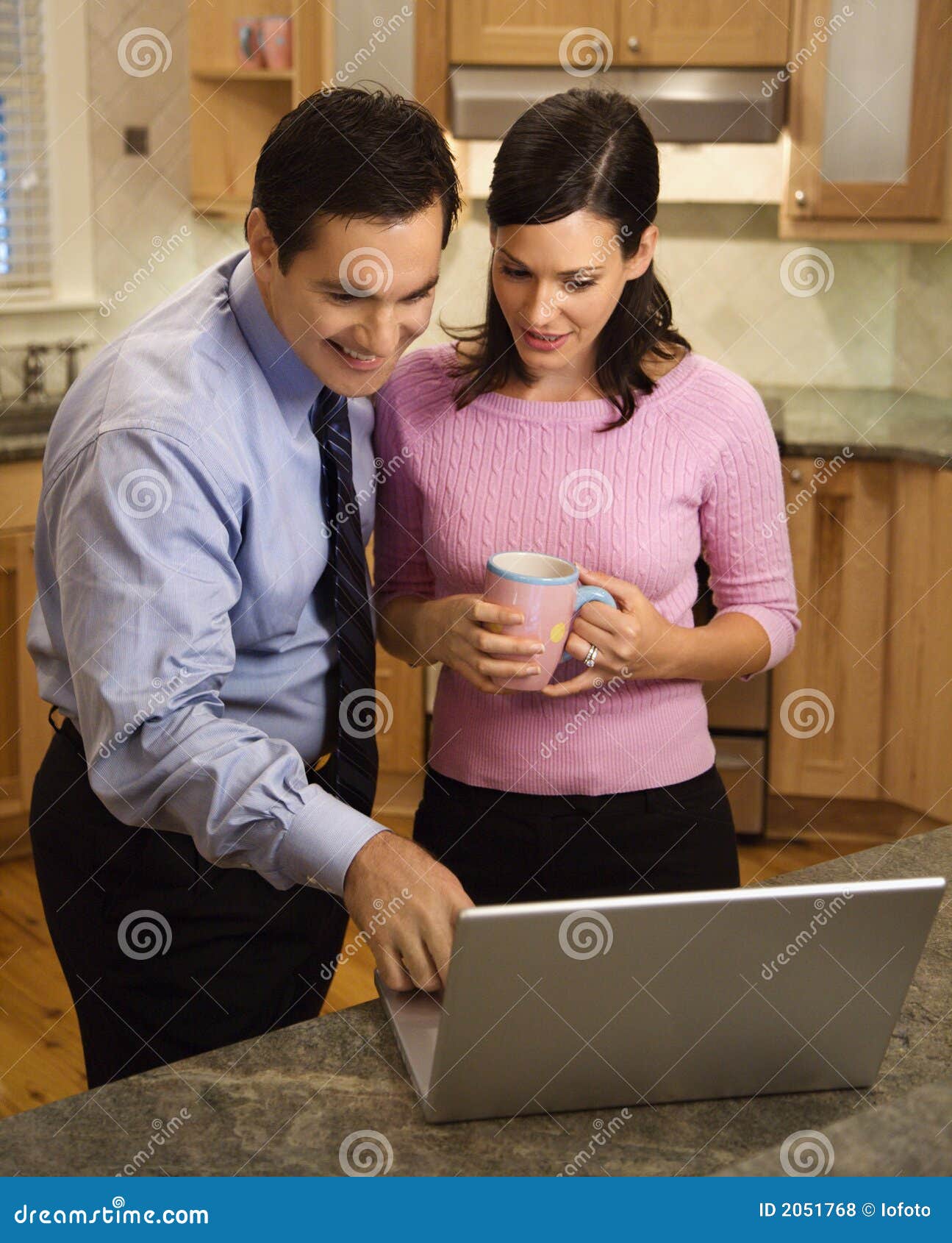 Couple looking at laptop. stock photo. Image of color - 2051768