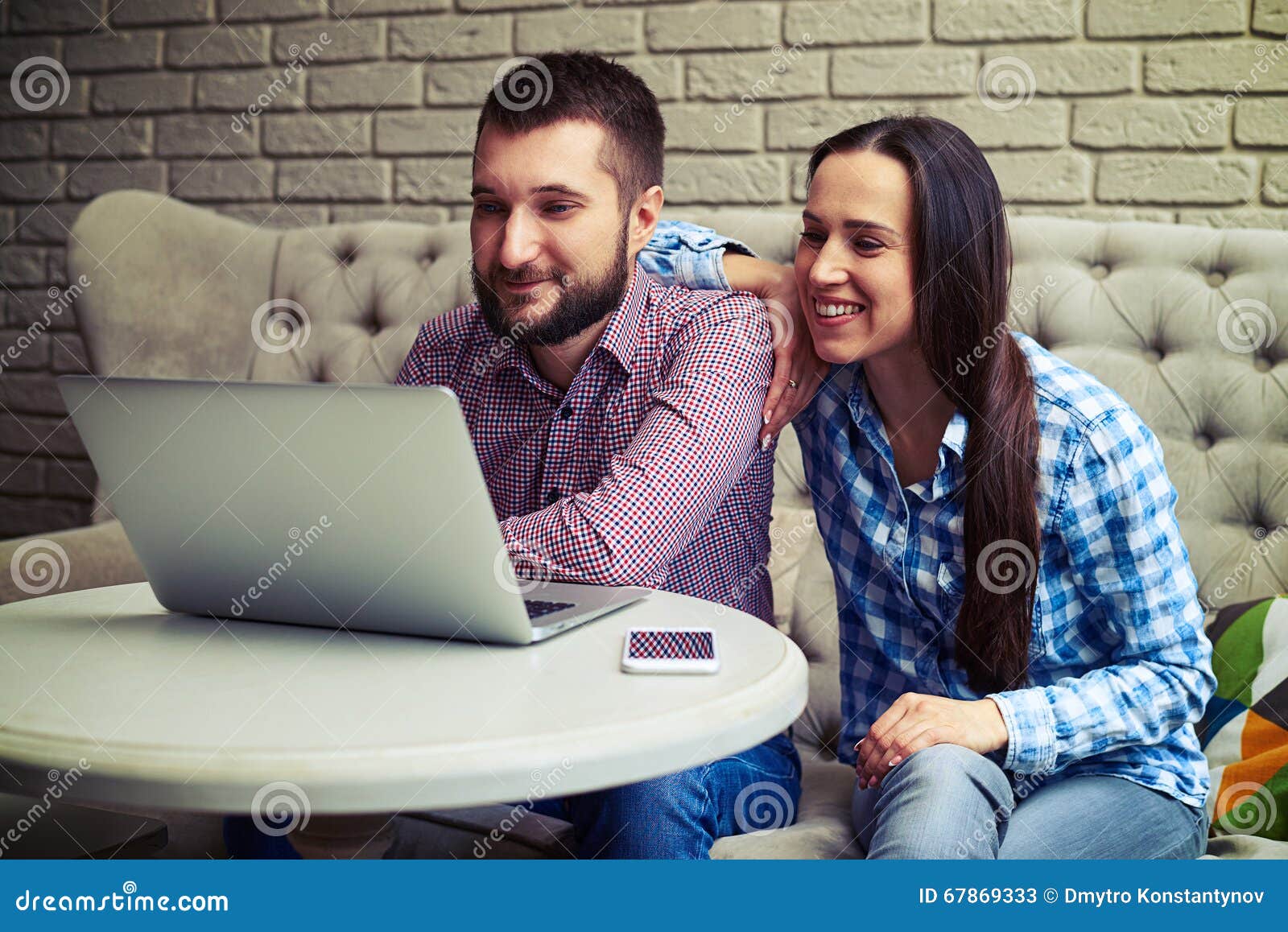 Couple looking at laptop stock image. Image of device - 67869333