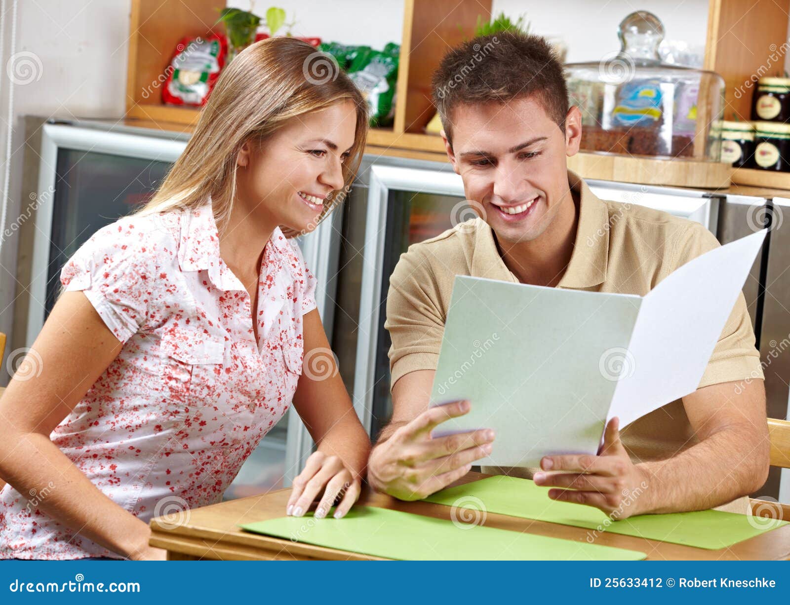 Couple looking at menu stock photo. Image of cafe, drink - 25633412