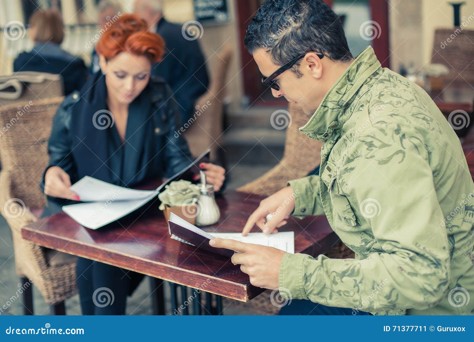 Couple looking at the menu stock image. Image of cuisine - 71377711