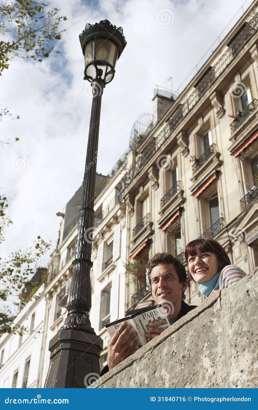 Couple Looking Over Bridge with Guidebook Stock Photo - Image of ...