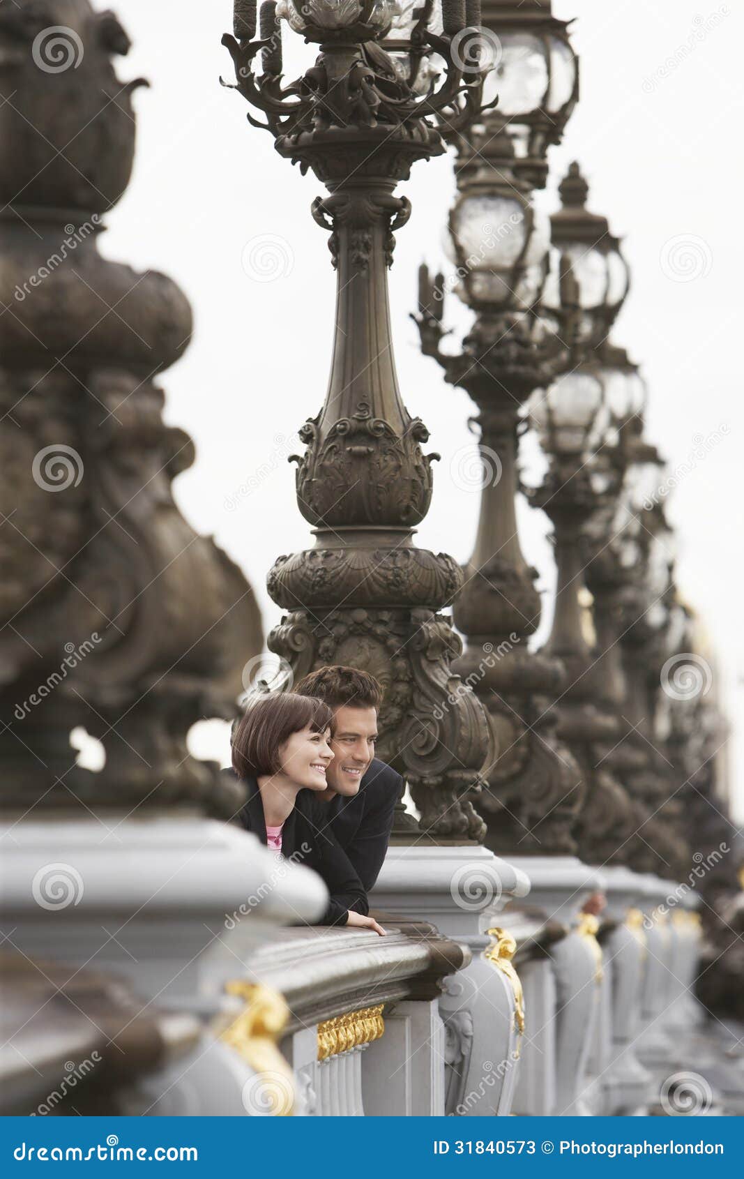 Couple Looking Over Bridge through Streetlights Stock Image - Image of ...