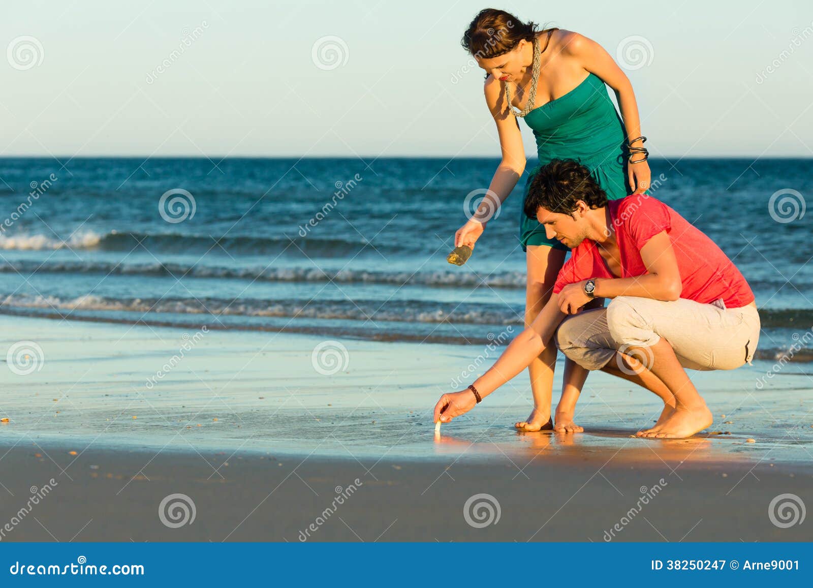 Couple Looking for Shells at Sunset Stock Image - Image of freedom ...