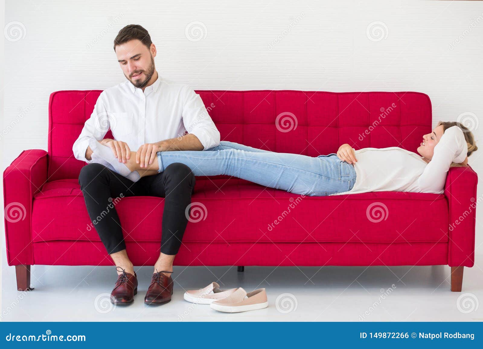 Young Man Sit On Couch Feel Unwell Blowing Running Nose With Napkin At