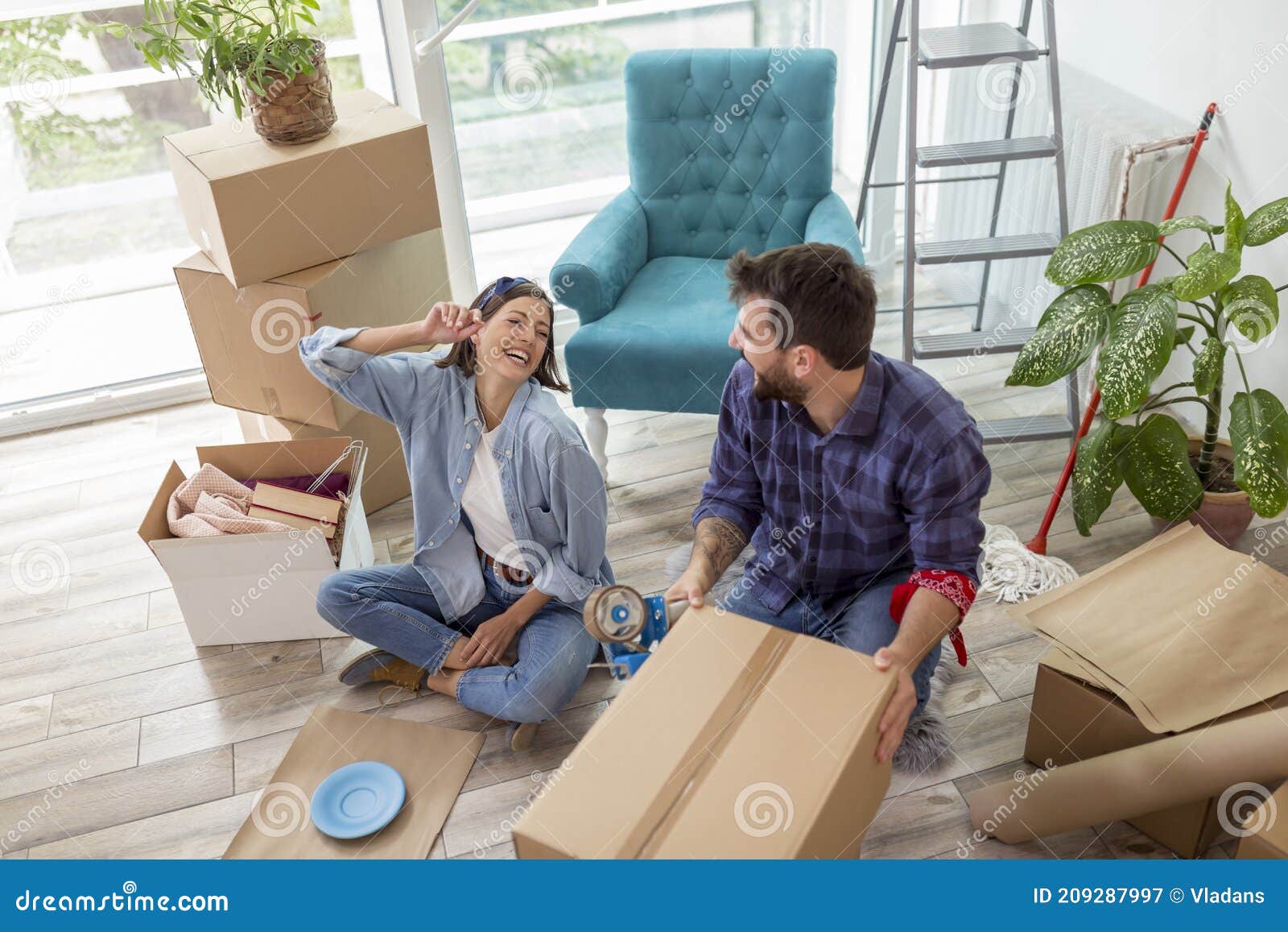 Couple Packing Their Possessions into Cardboard Boxes while Moving ...