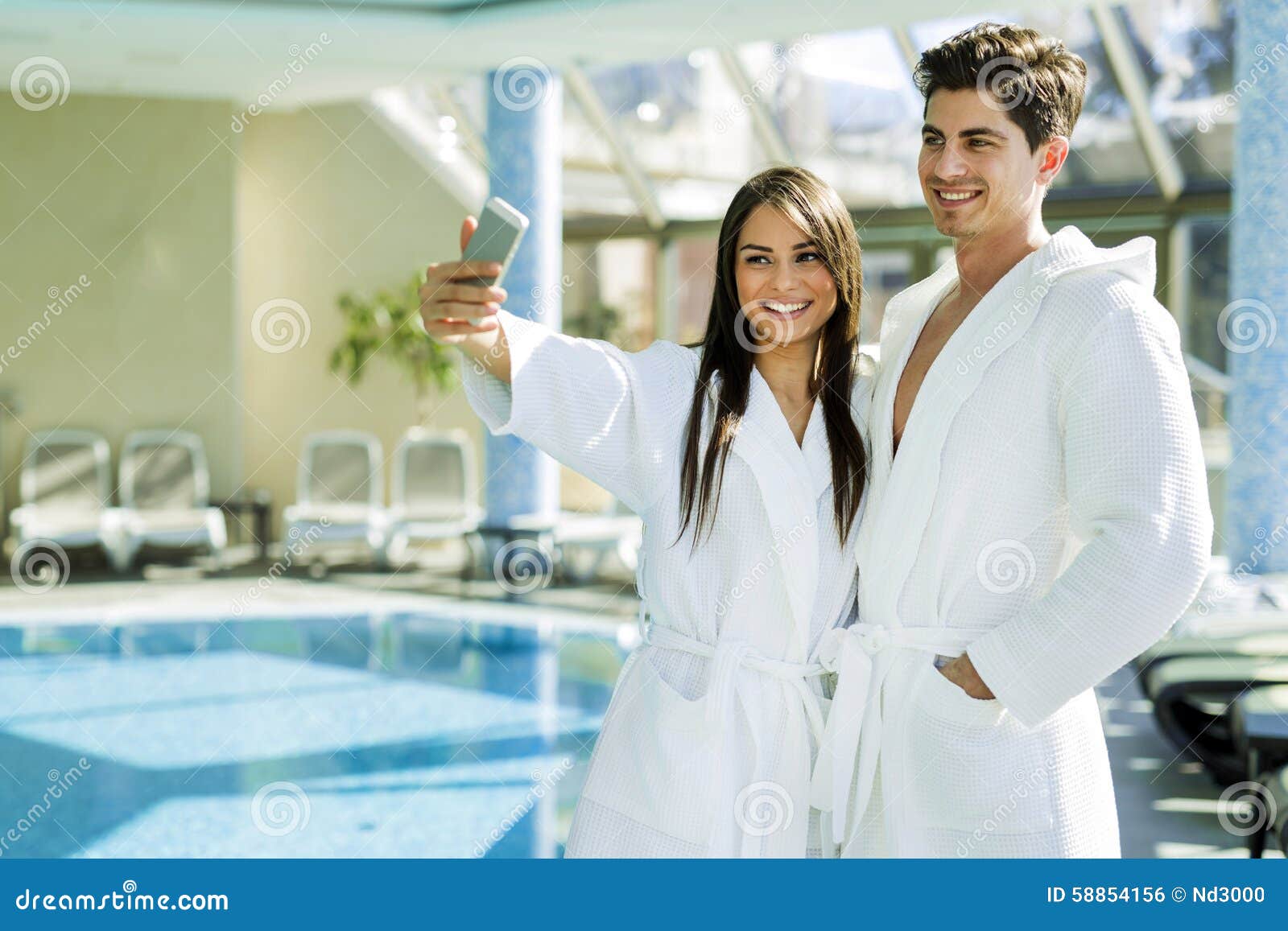 Couple in Love Standing Next To a Pool in a Robe Stock Photo - Image of ...