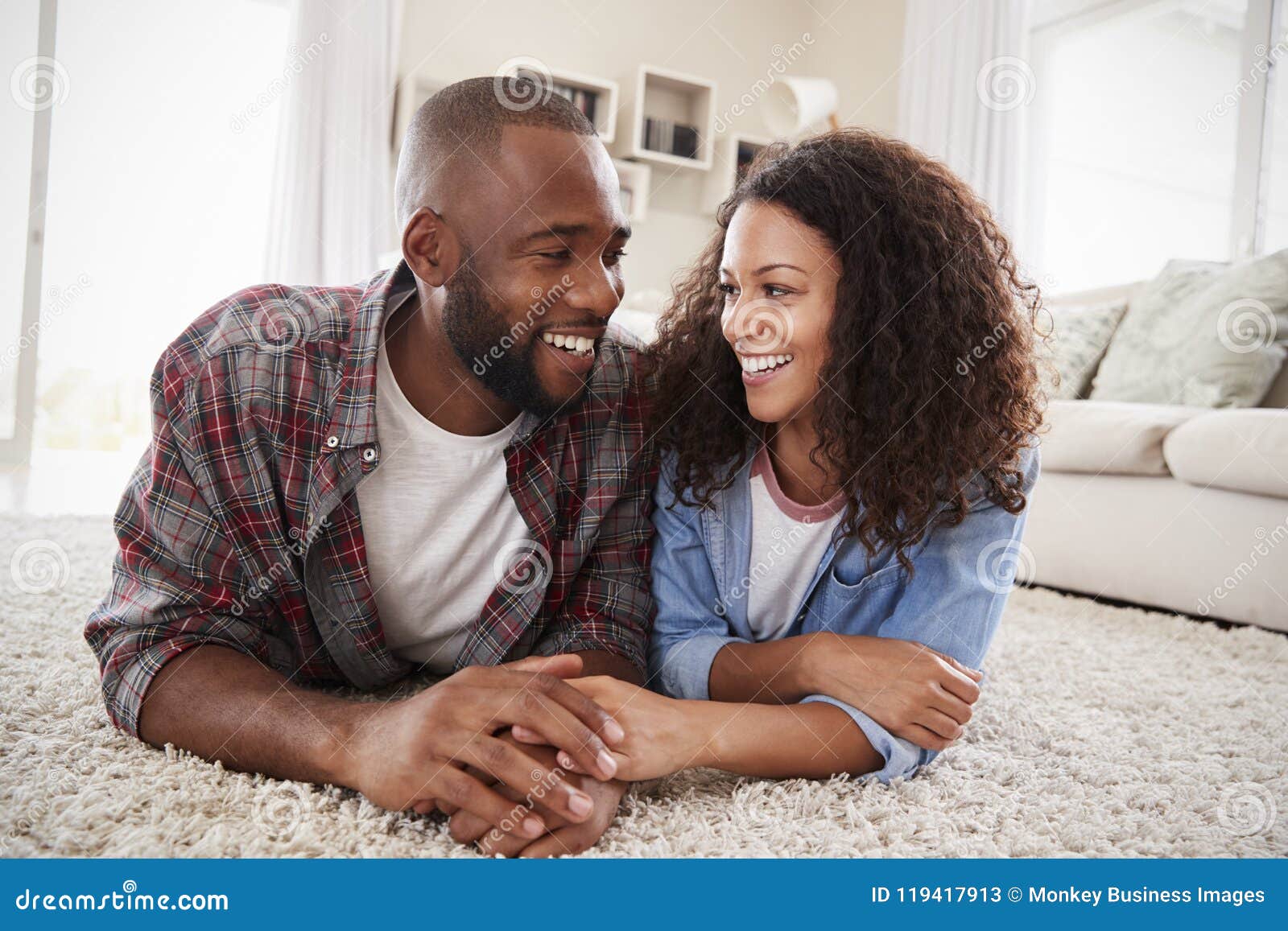 Couple Lying on Rug in Lounge at Home Stock Image - Image of lying ...