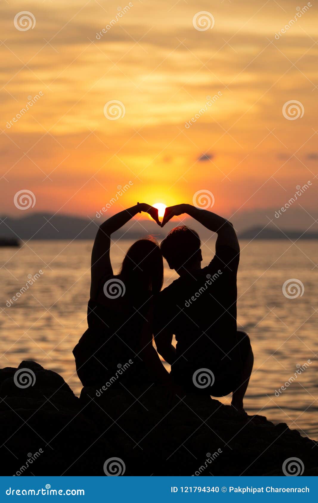 Couple Making Heart Shape on the Beach in Sunset. Stock Photo - Image ...