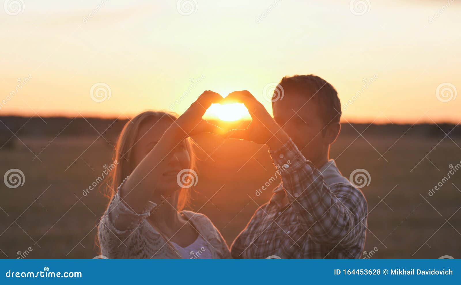 Couple Making Heart Shape with Hands. Sunset Time. Stock Photo - Image ...