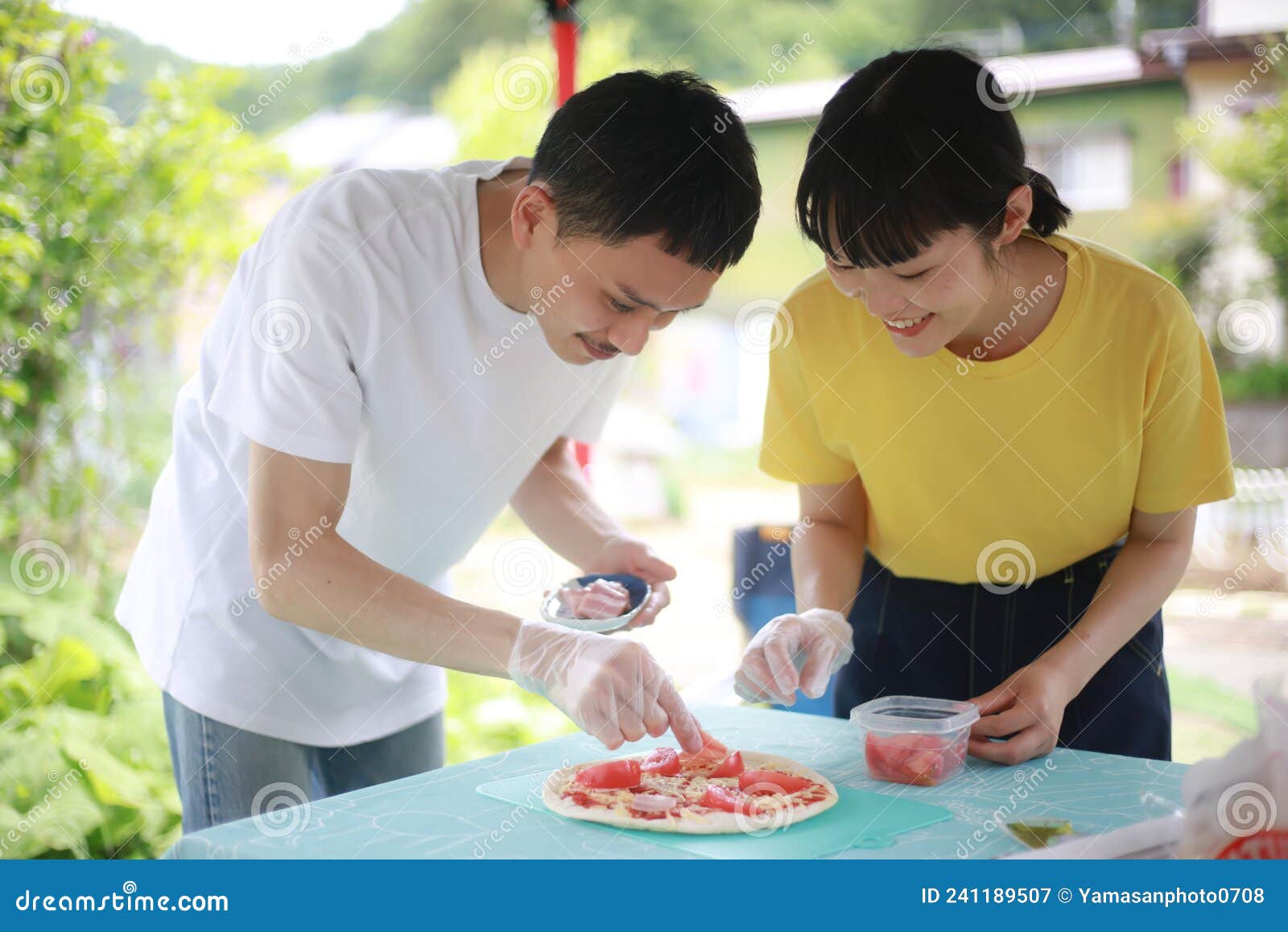 A couple making pizza stock image. Image of travel, woman - 241189507