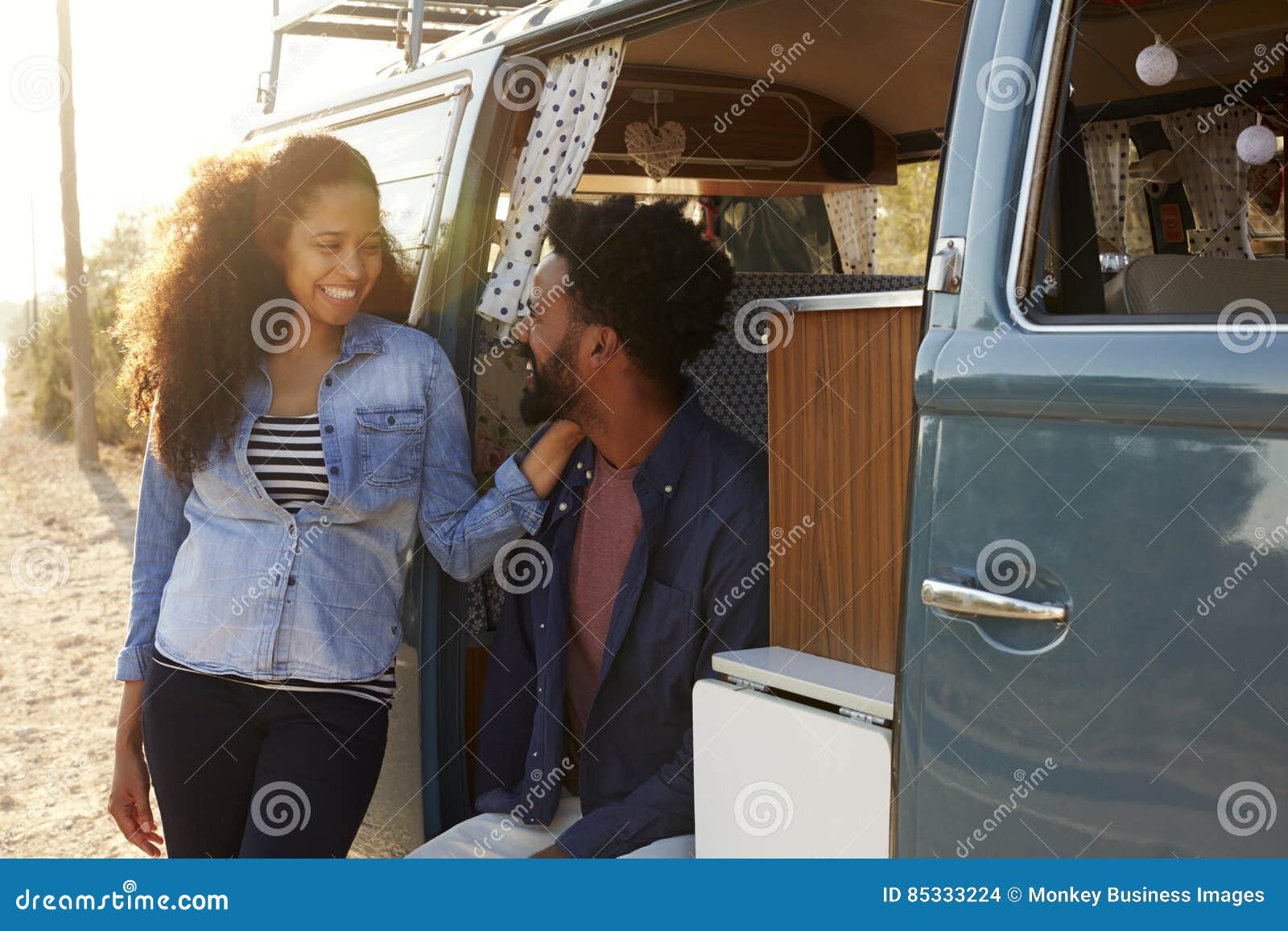 Couple Making a Roadside Stop in Their Van Look at Each Other Stock ...