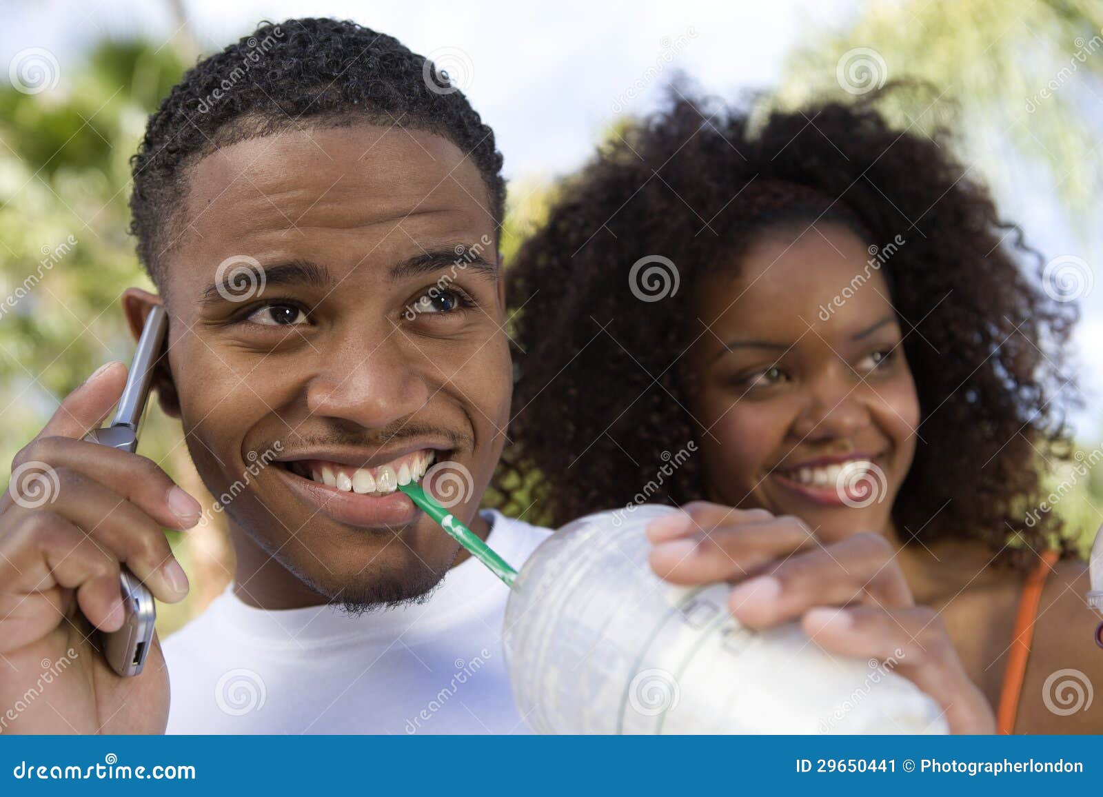 Couple with Man on Call Sipping Milkshake Stock Image - Image of ...