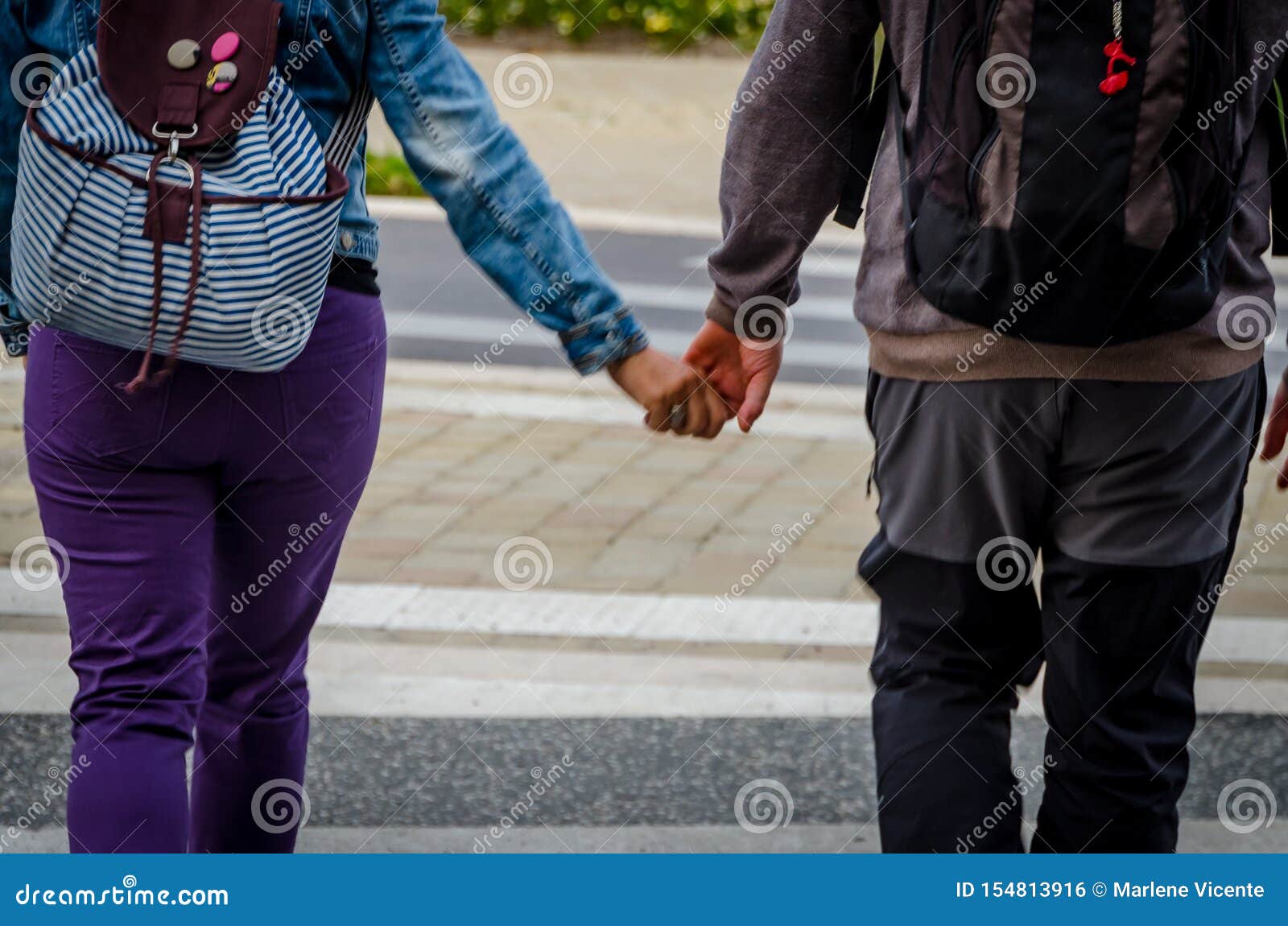 Couple of Man and Woman Holding Hands with Backpack, on Their Backs ...