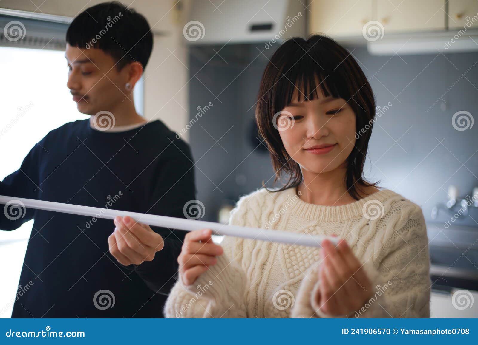 A Couple Measuring the Room with a Major Stock Photo - Image of ...