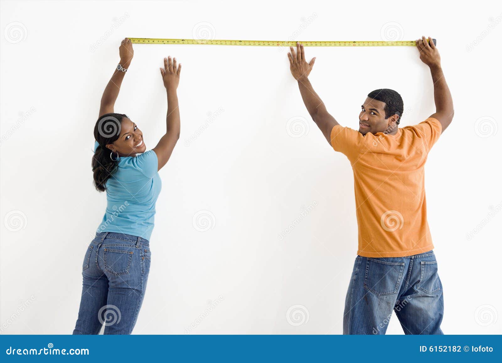 Couple measuring wall. stock photo. Image of african, adult - 6152182