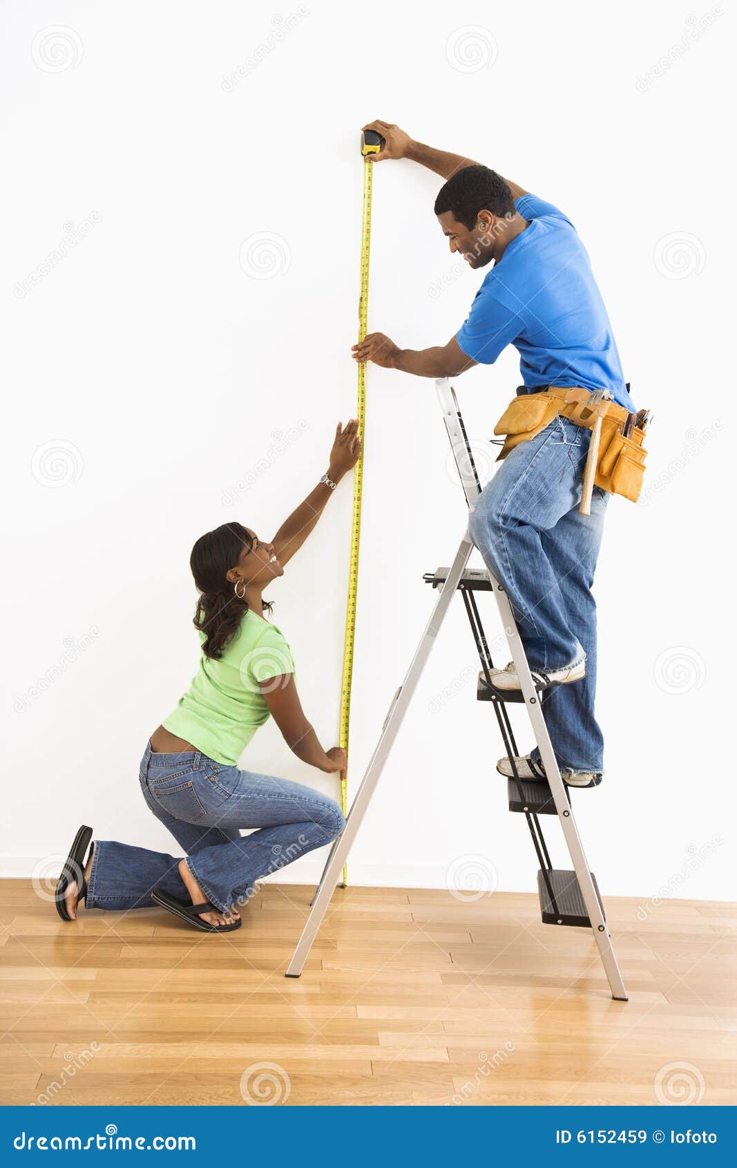 Couple measuring wall. stock image. Image of indoors, floor - 6152459