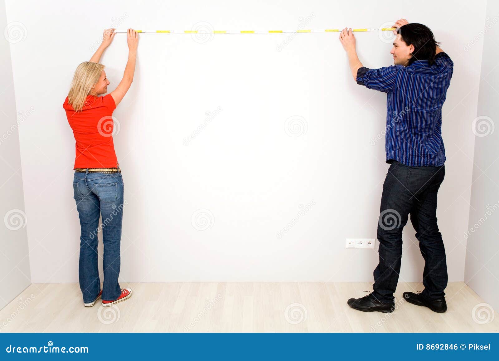Couple measuring wall stock photo. Image of flat, cooperation - 8692846