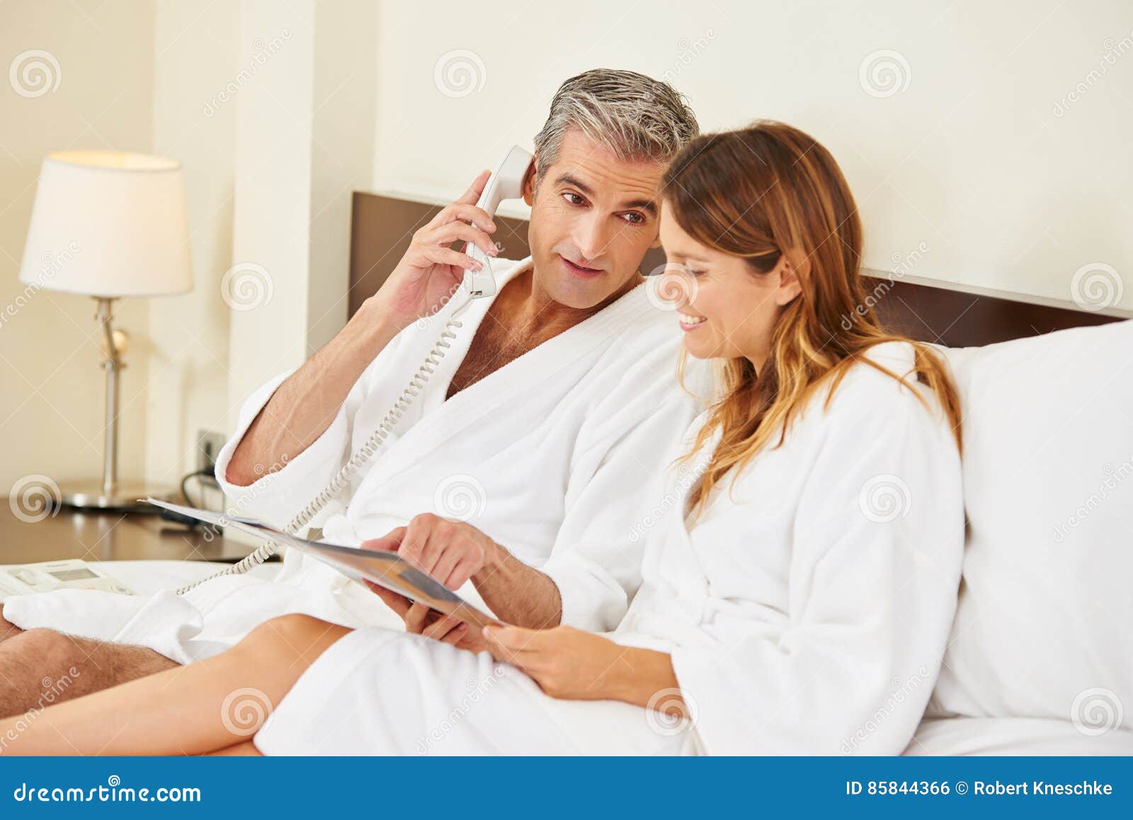 Couple with Menu Calling Room Service from Hotel Stock Photo - Image of ...