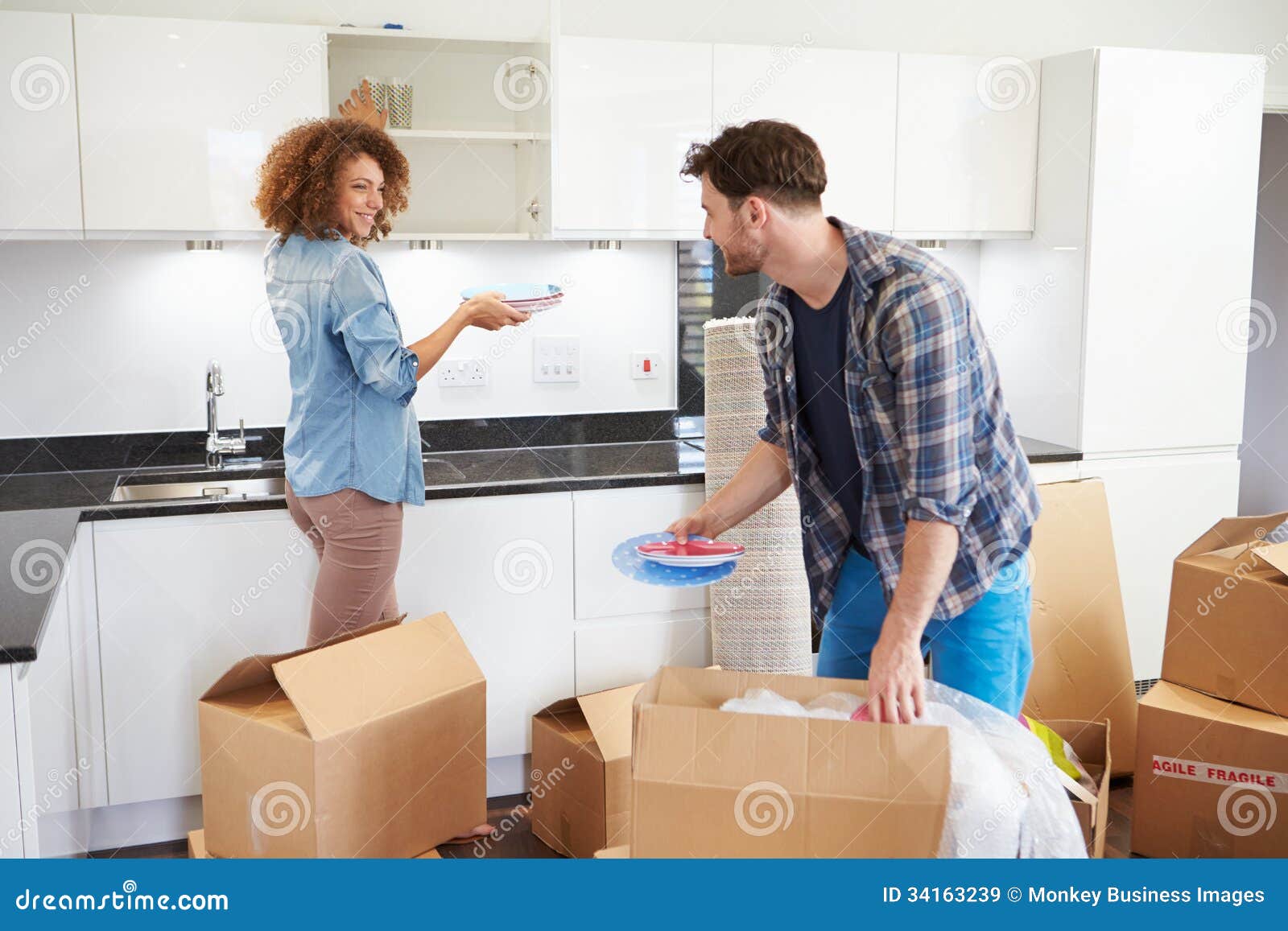Couple Moving into New Home and Unpacking Boxes Stock Image - Image of ...