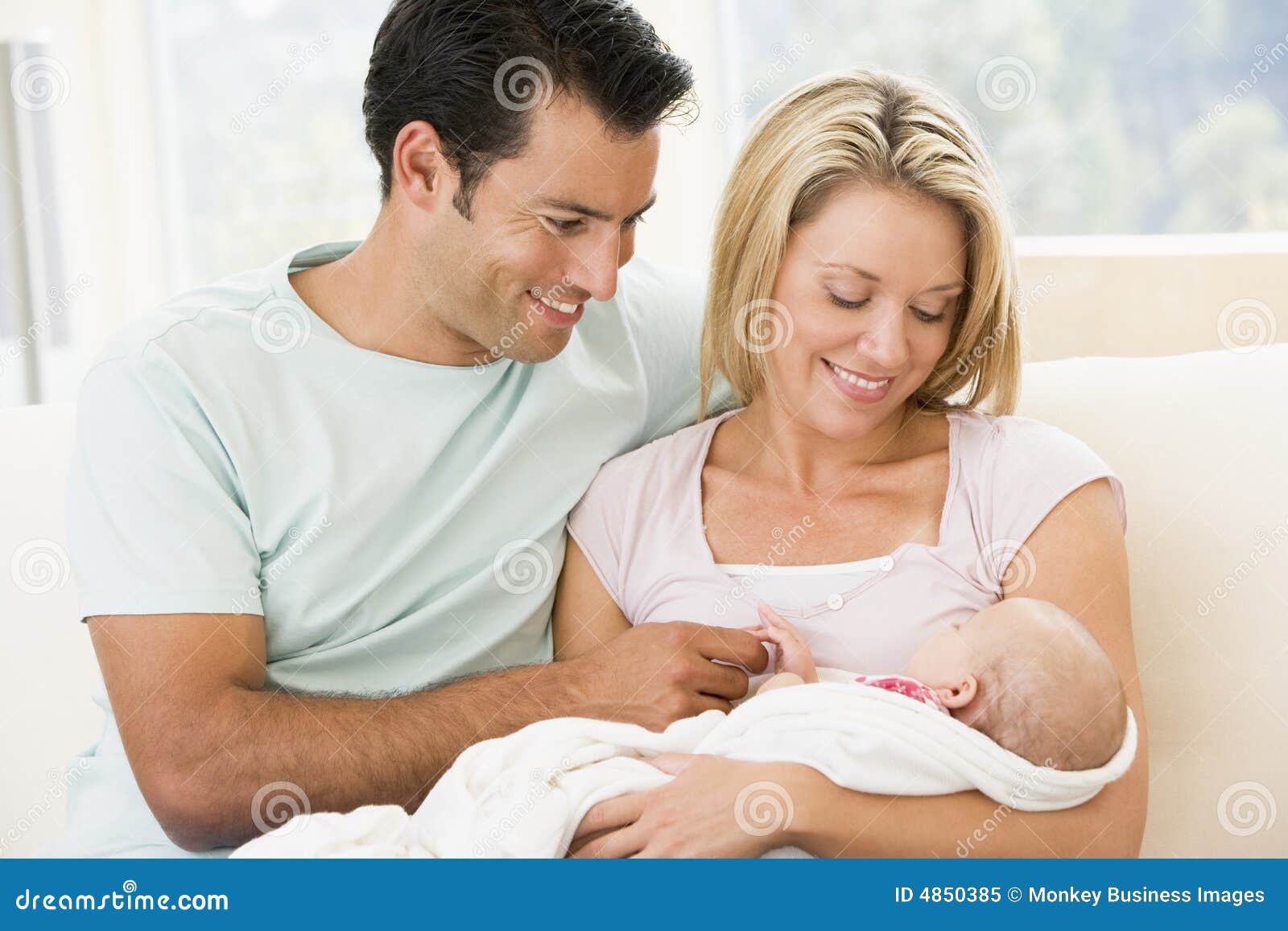 Couple With New Baby At Home Royalty Free Stock Photo - Image: 4850385