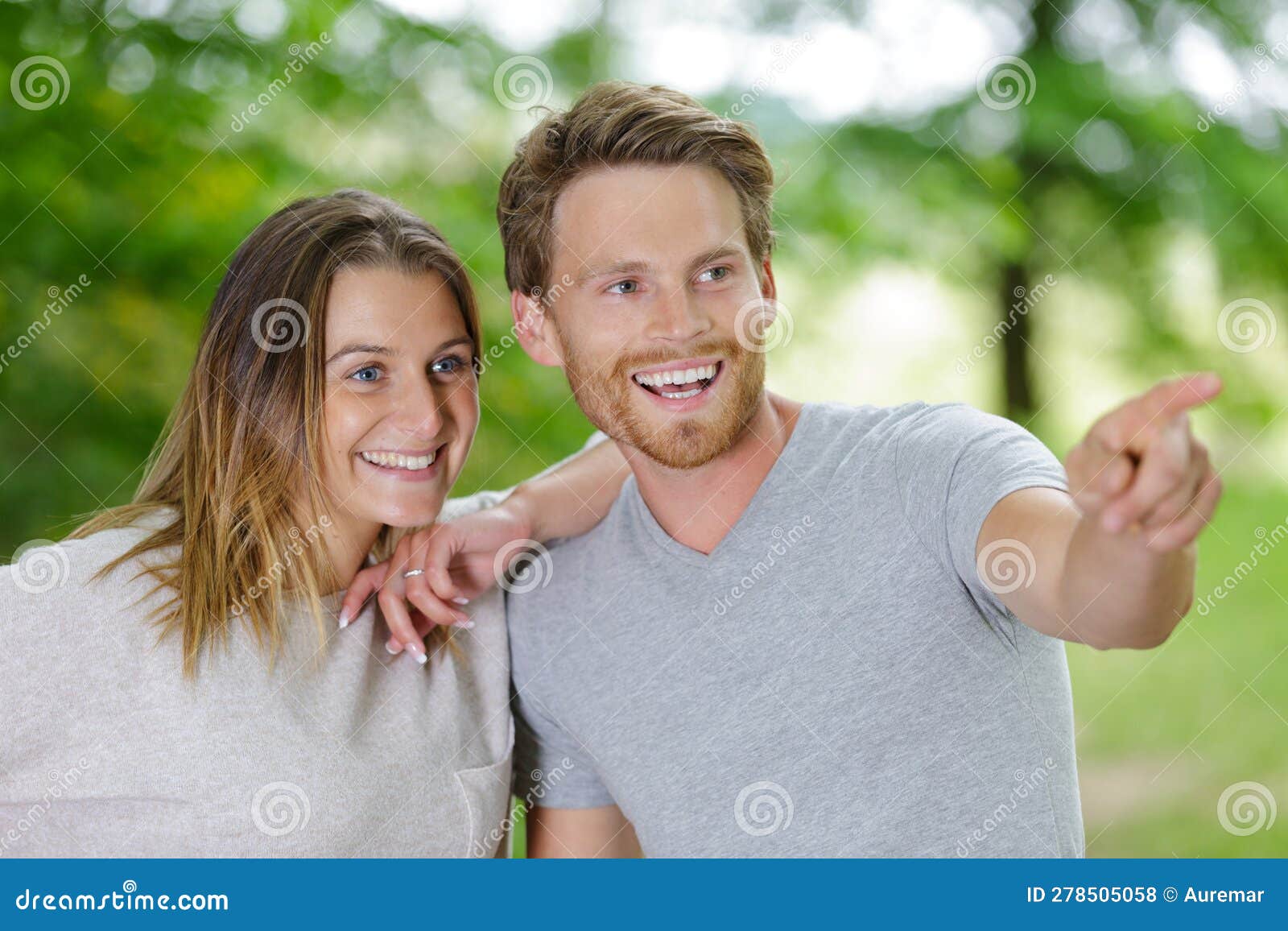 Couple Out Walking Man Pointing into Distance Stock Photo - Image of ...