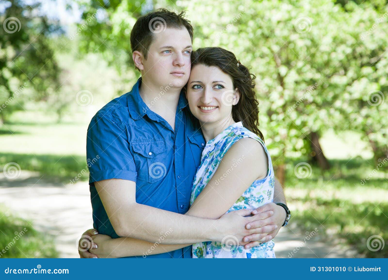 Couple Outdoors Looking Forward Stock Photo - Image of embracing, green ...