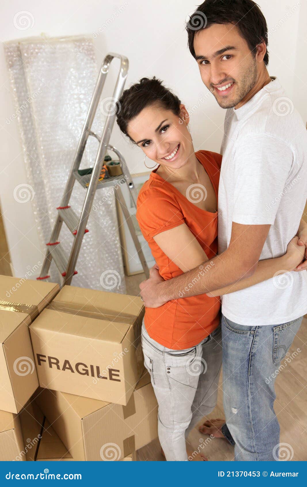 Couple with packing boxes stock image. Image of embrace - 21370453