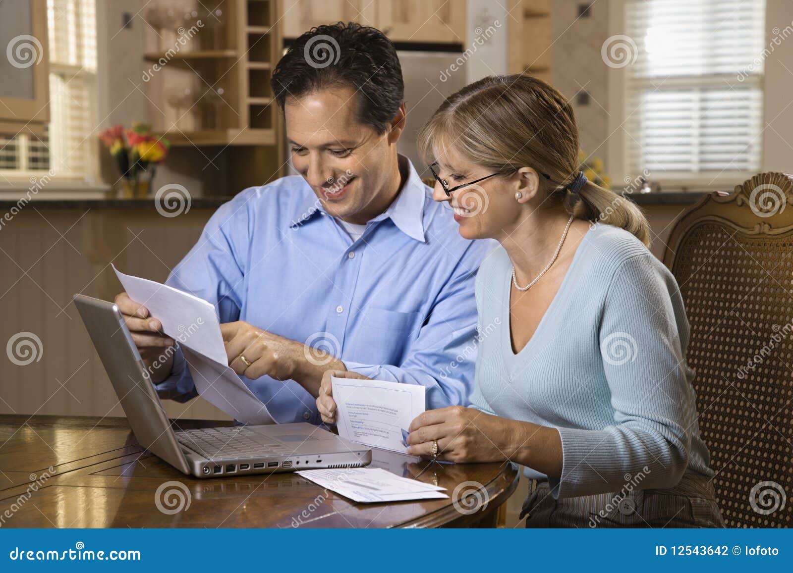 Couple Paying Bills Online stock photo. Image of husband - 12543642