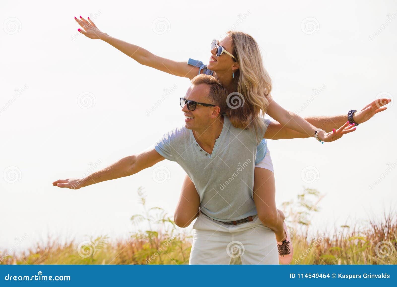 Couple Piggybacking Outdoors Stock Photo - Image of male, people: 114549464
