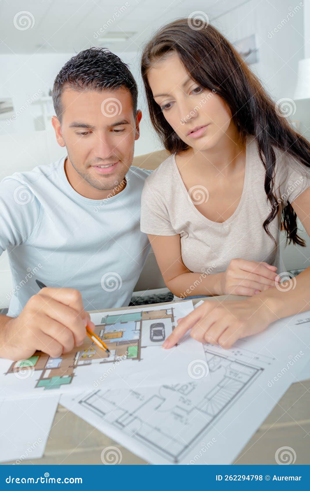 Couple with Plans Showing Layout Property Stock Photo - Image of ...