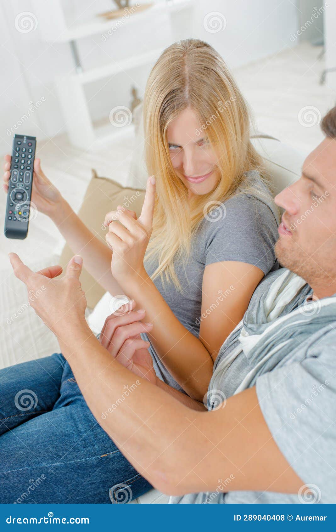 Couple Playfully Arguing Over Remote Control Stock Photo - Image of ...