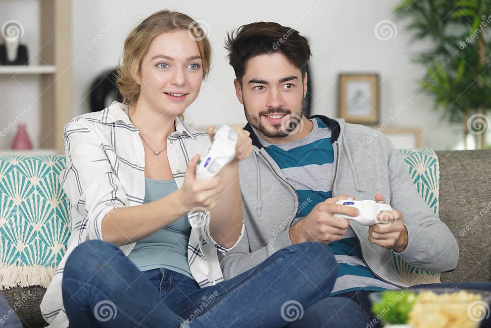 Couple Playing Computer Games Sitting on Sofa at Home Stock Image ...