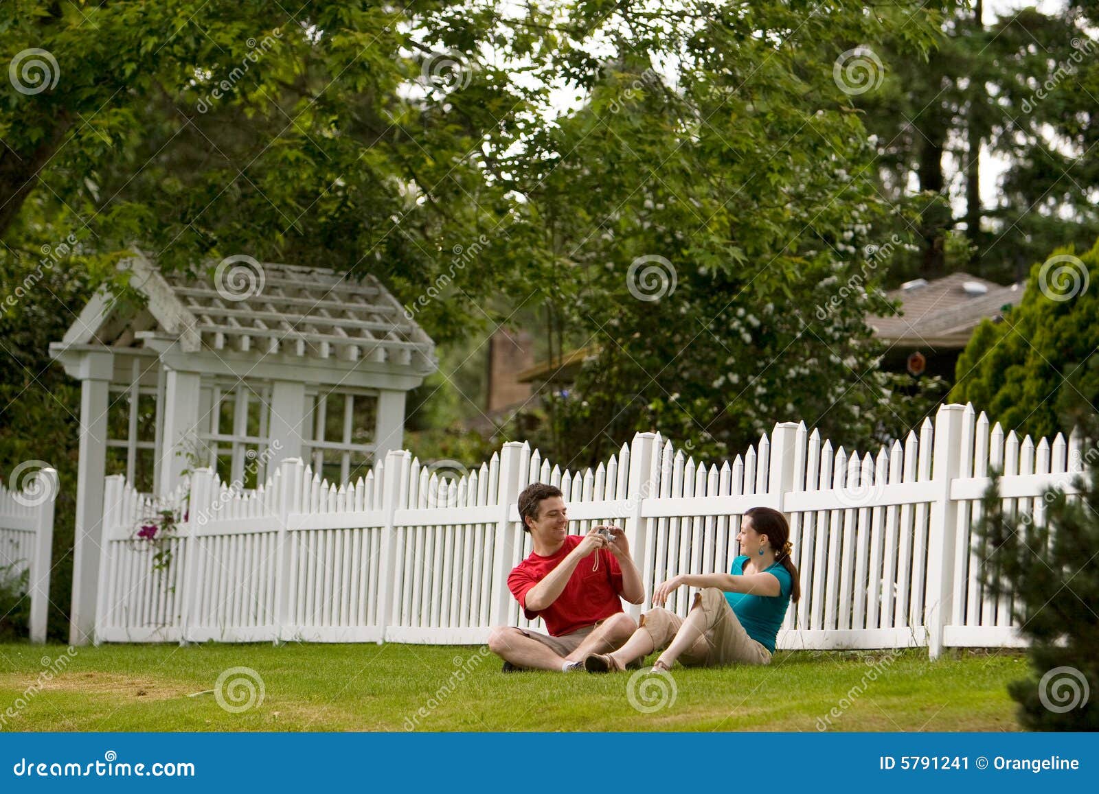 Couple Playing by Fence - Horizontal Stock Image - Image of beautiful ...
