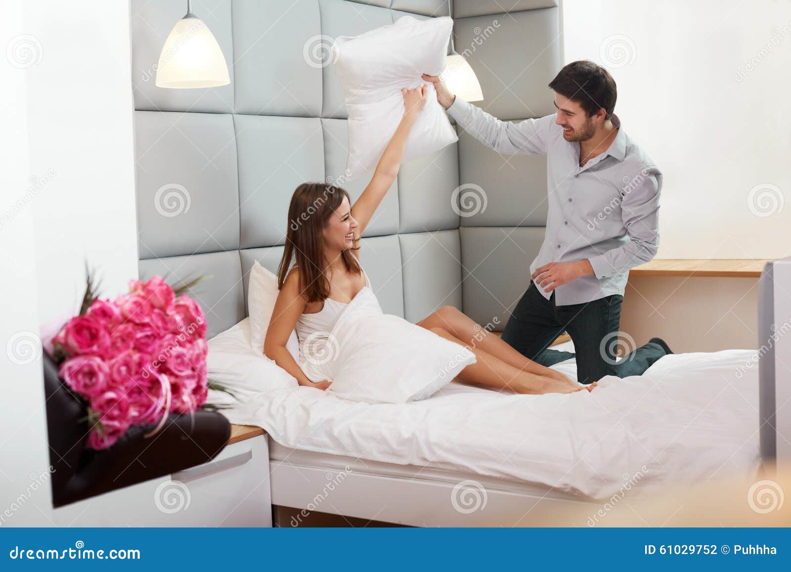 Couple Playing and Having a Pillow Fight in Bed Stock Photo - Image of ...