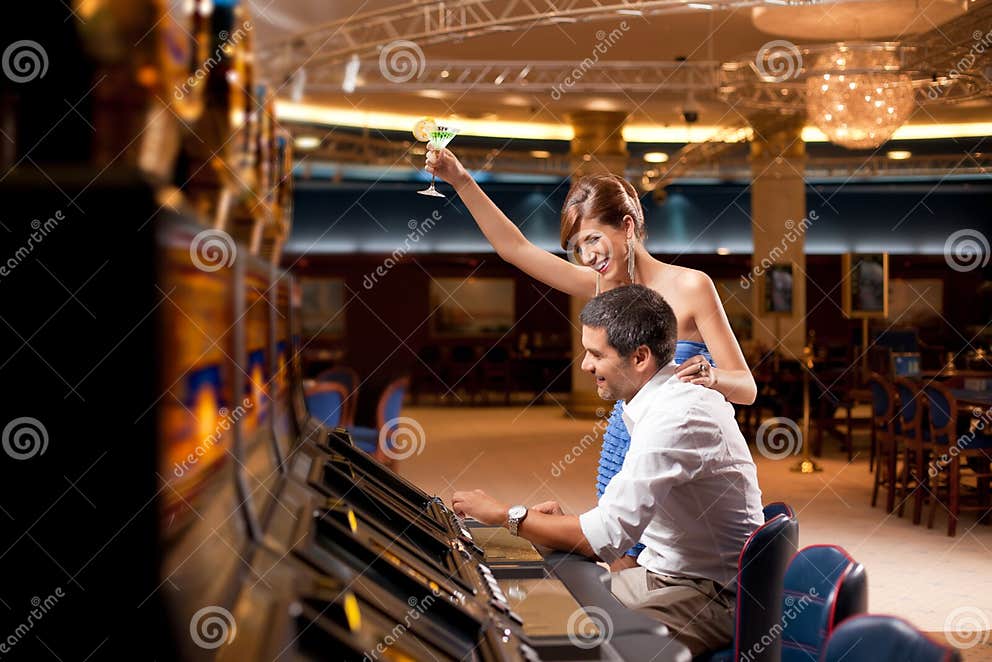 Couple Playing the Slot Machine Stock Image - Image of casino, hand ...