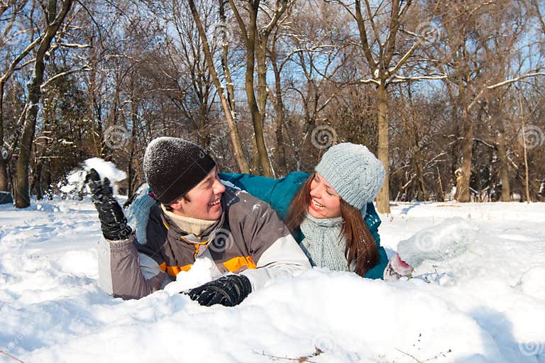 Couple playing in snow stock image. Image of nature, looking - 12890099