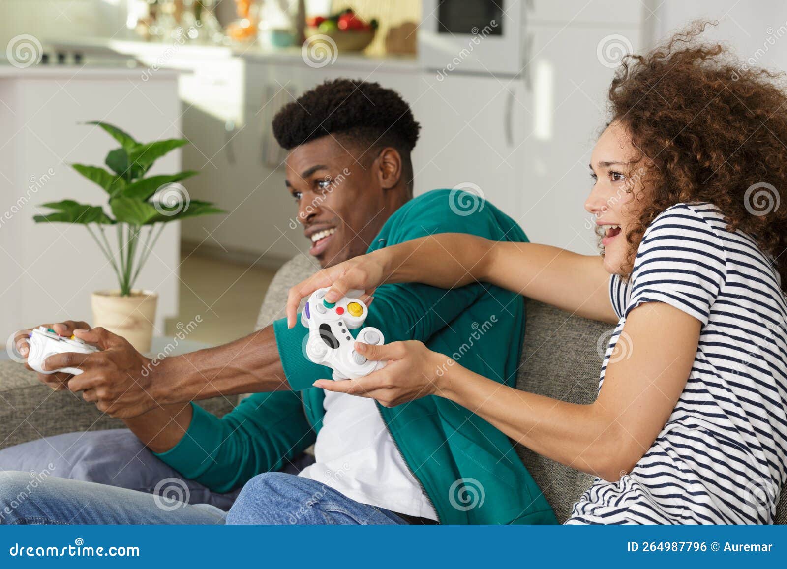 Couple Playing Video Games on Sofa Stock Photo - Image of games, home ...