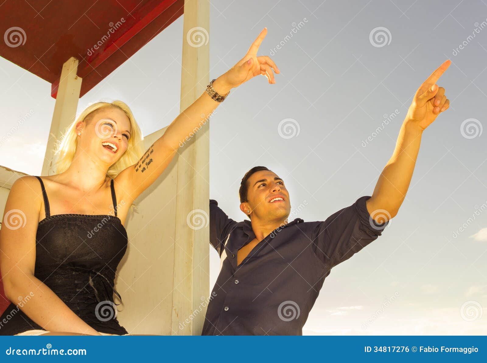 Couple pointing the sky stock photo. Image of smiling - 34817276